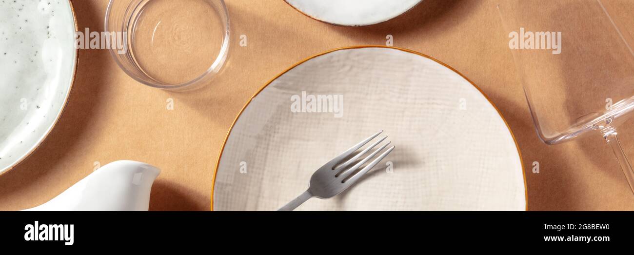 Tableware panorama with plates and glasses, shot from above. Dinnerware ...