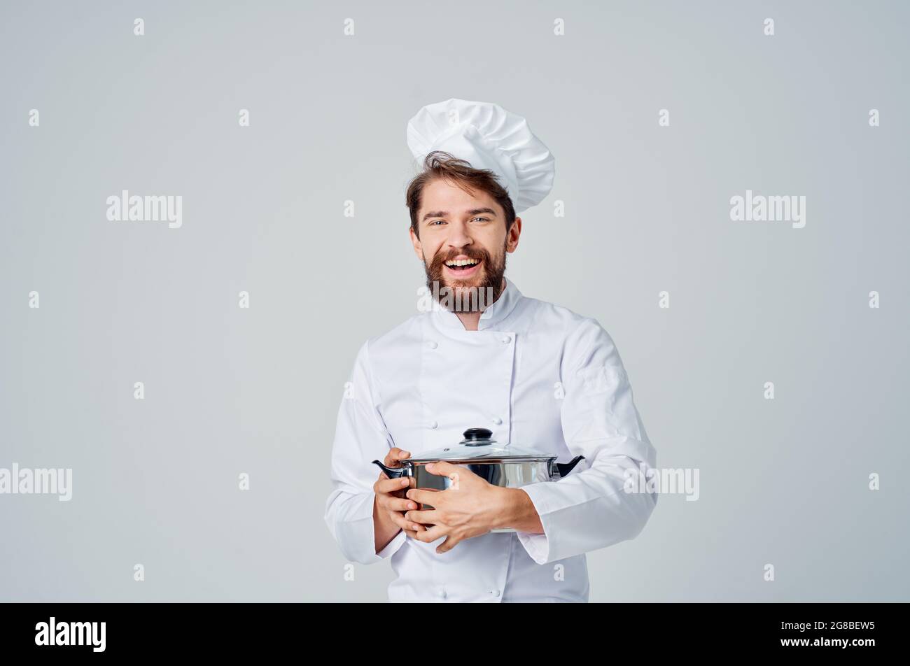 male chef with a saucepan in his hands cooking food kitchen lifestyle ...