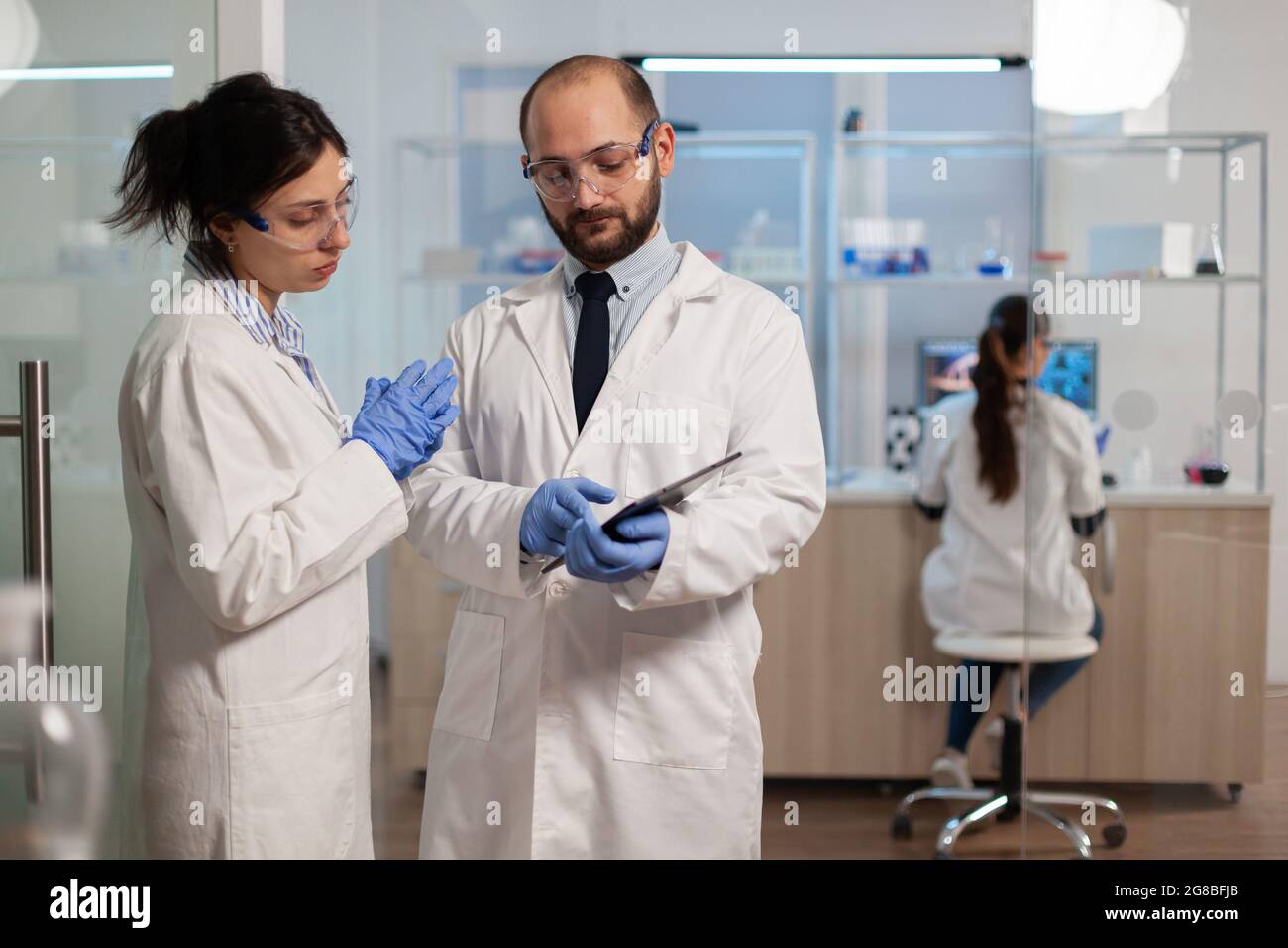 Chemist nurse explainig to doctor vaccine development in modern ...