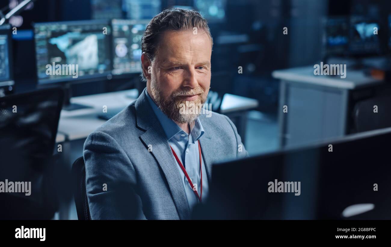 Portrait of Positive Professional Technical Controller Sitting at His ...