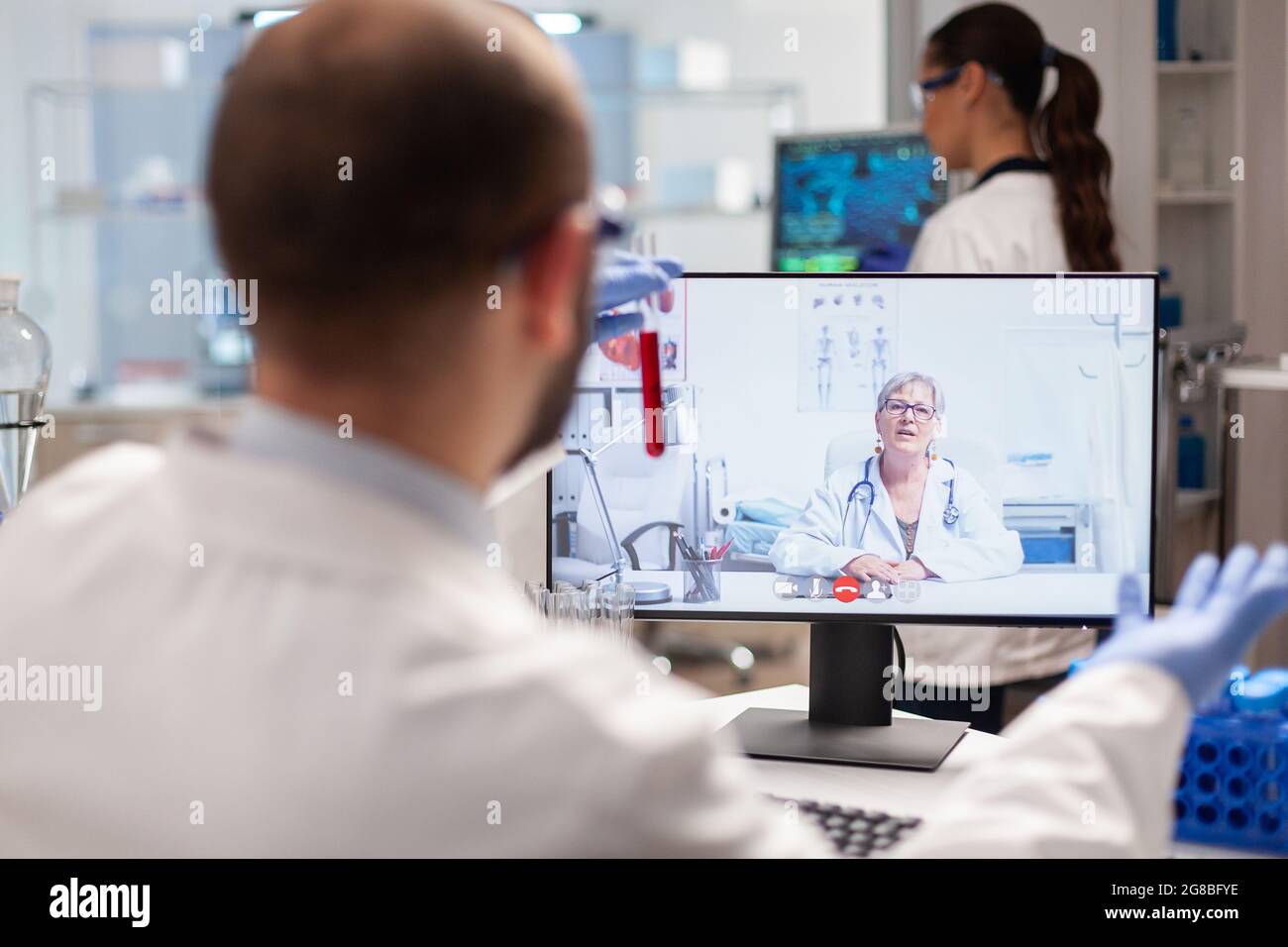 Chemistry researcher discussing about virus vaccine with doctor during ...