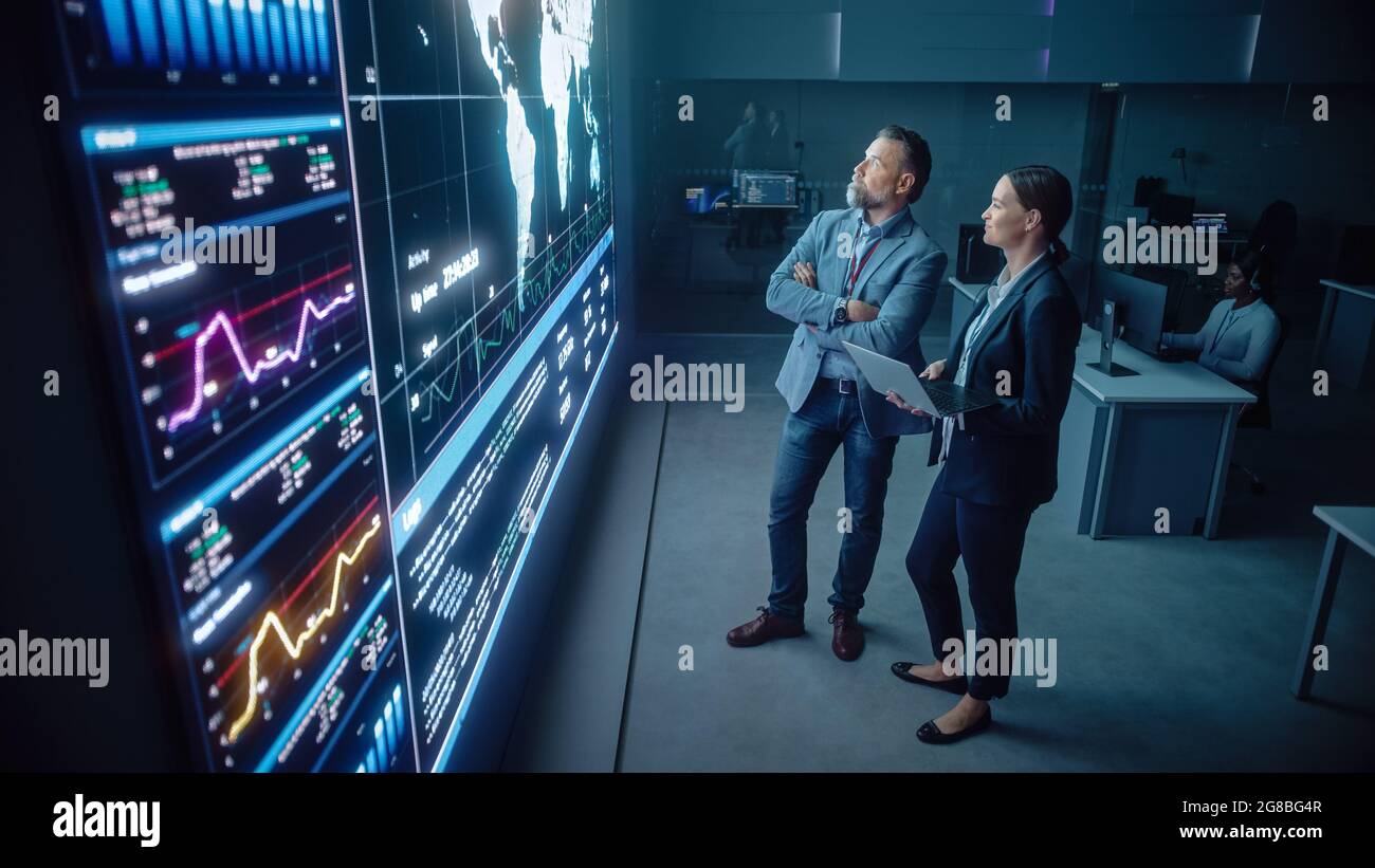 Project Manager and Computer Science Engineer Talk while Using Big ...