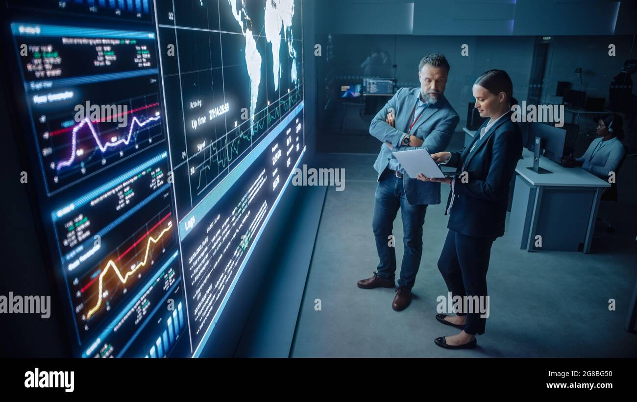 Project Manager and Computer Science Engineer Talk while Using Big ...