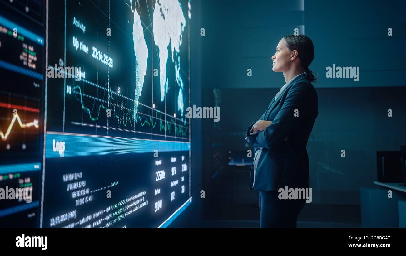 Young Female Computer Science Engineer Looking at Big Screen Display ...