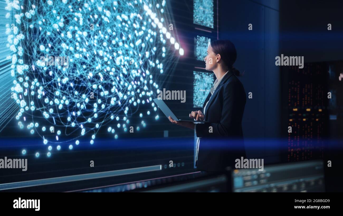 Young Female Computer Science Engineer Working on Laptop next at Big ...