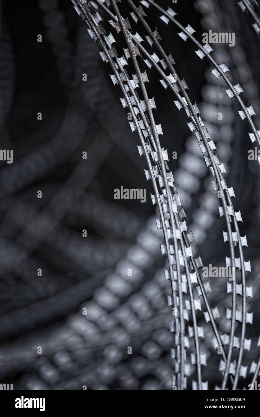Sharp metal barbed wire processed in grunge style Stock Photo - Alamy