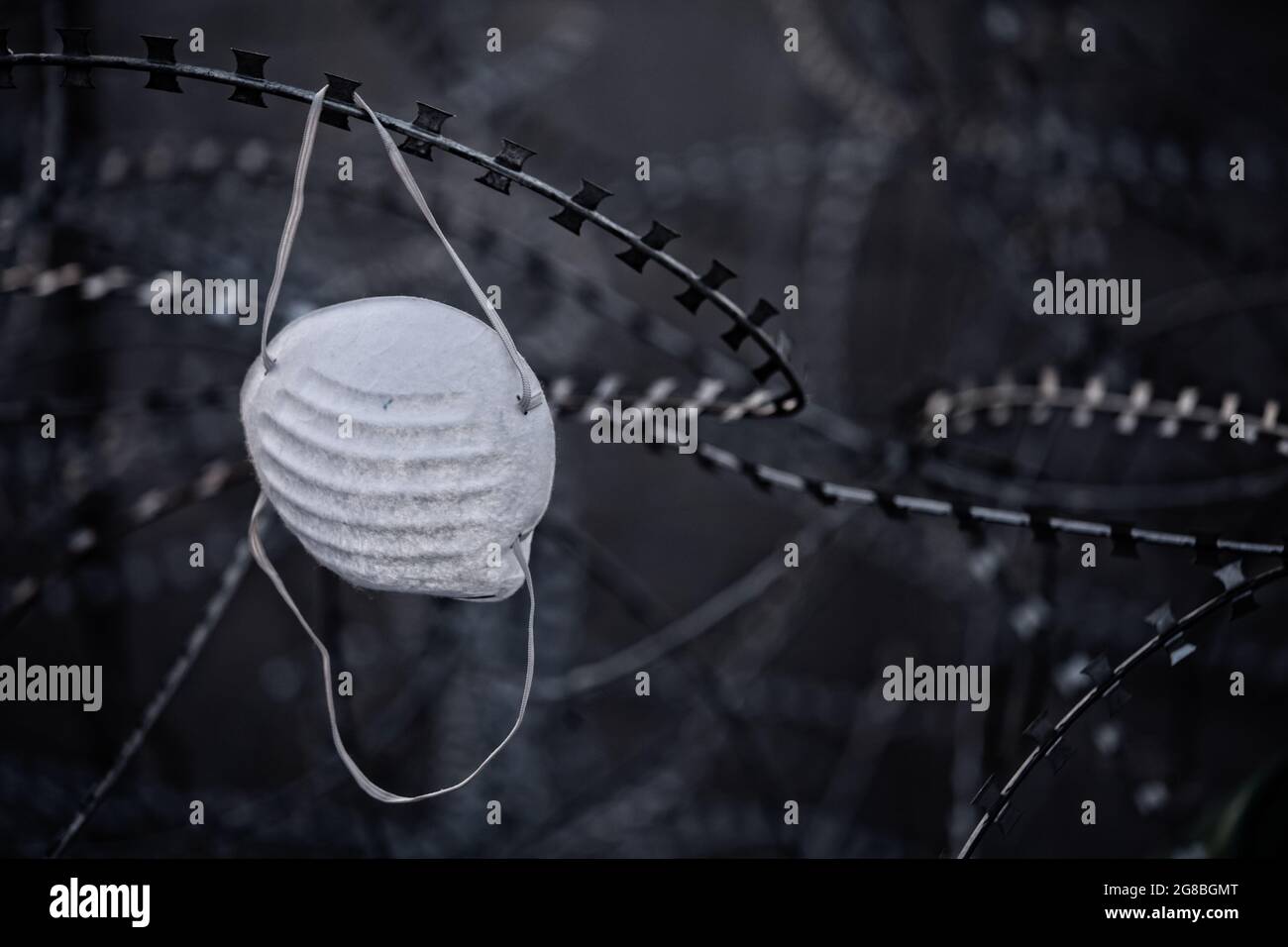 White mask hang on barbed wire, concept and symbol of protest and ...