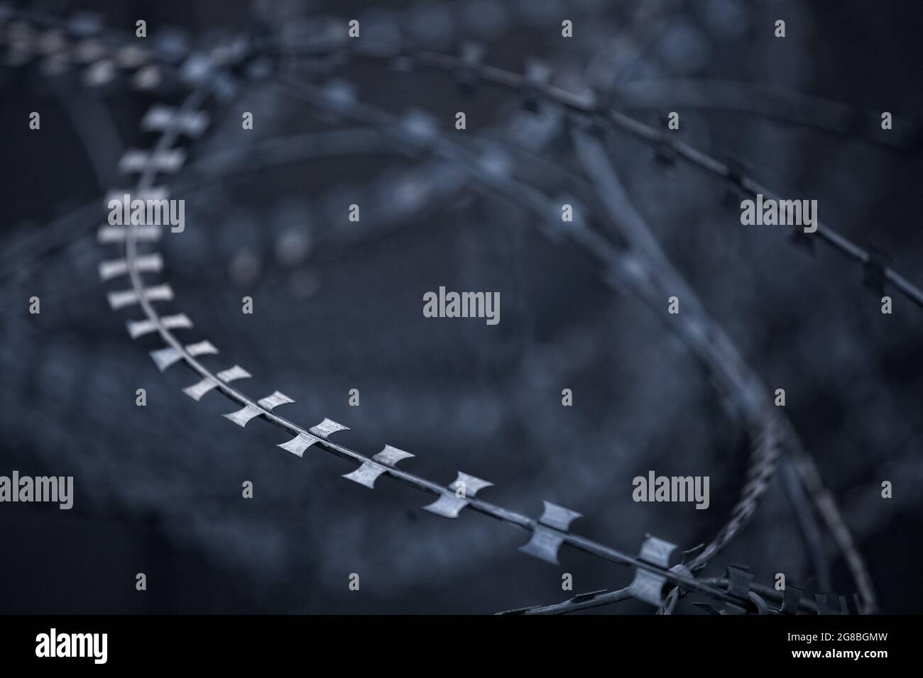 Sharp metal barbed wire processed in grunge style Stock Photo - Alamy