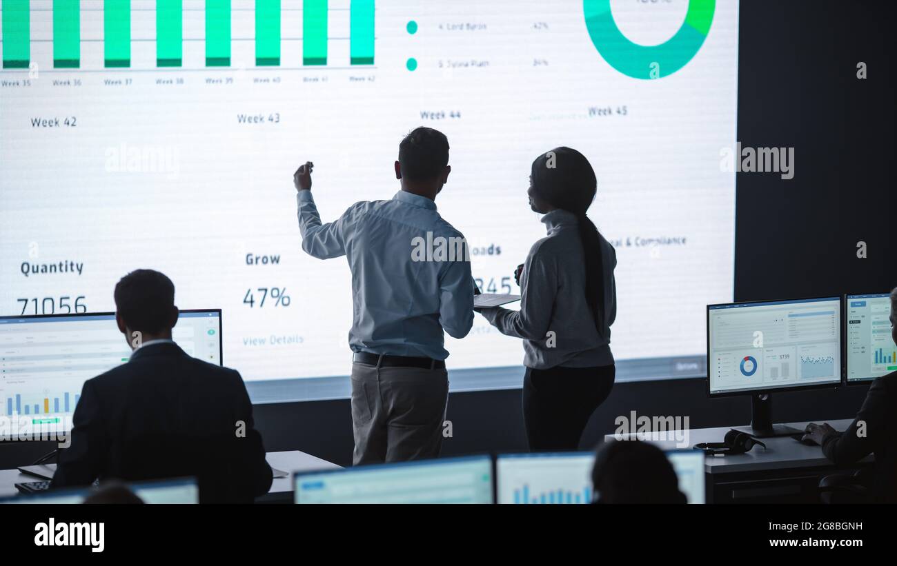 Two Traders Having a Meeting in a Modern Monitoring Office with ...