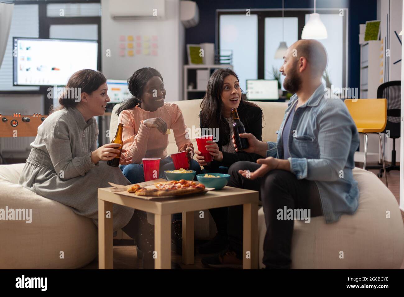 Multi Ethnic Colleagues Having Fun After Work At Office While Eating