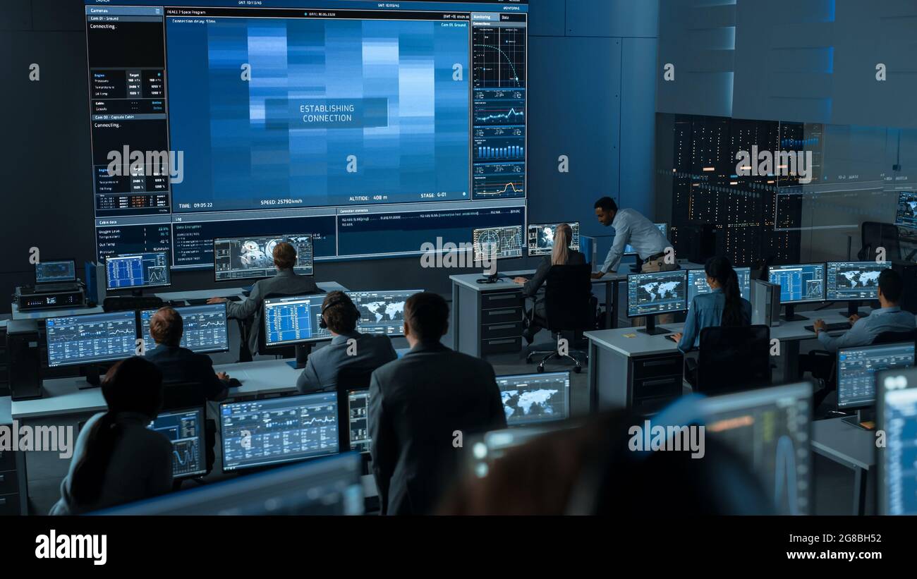 Group of People in Mission Control Center Trying to Establish Video ...