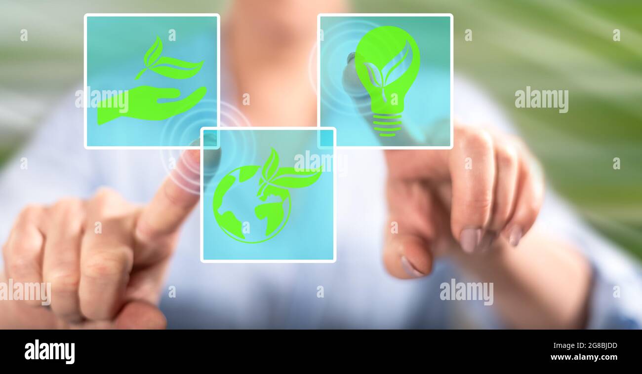 Woman touching an ecology concept on a touch screen with her fingers ...