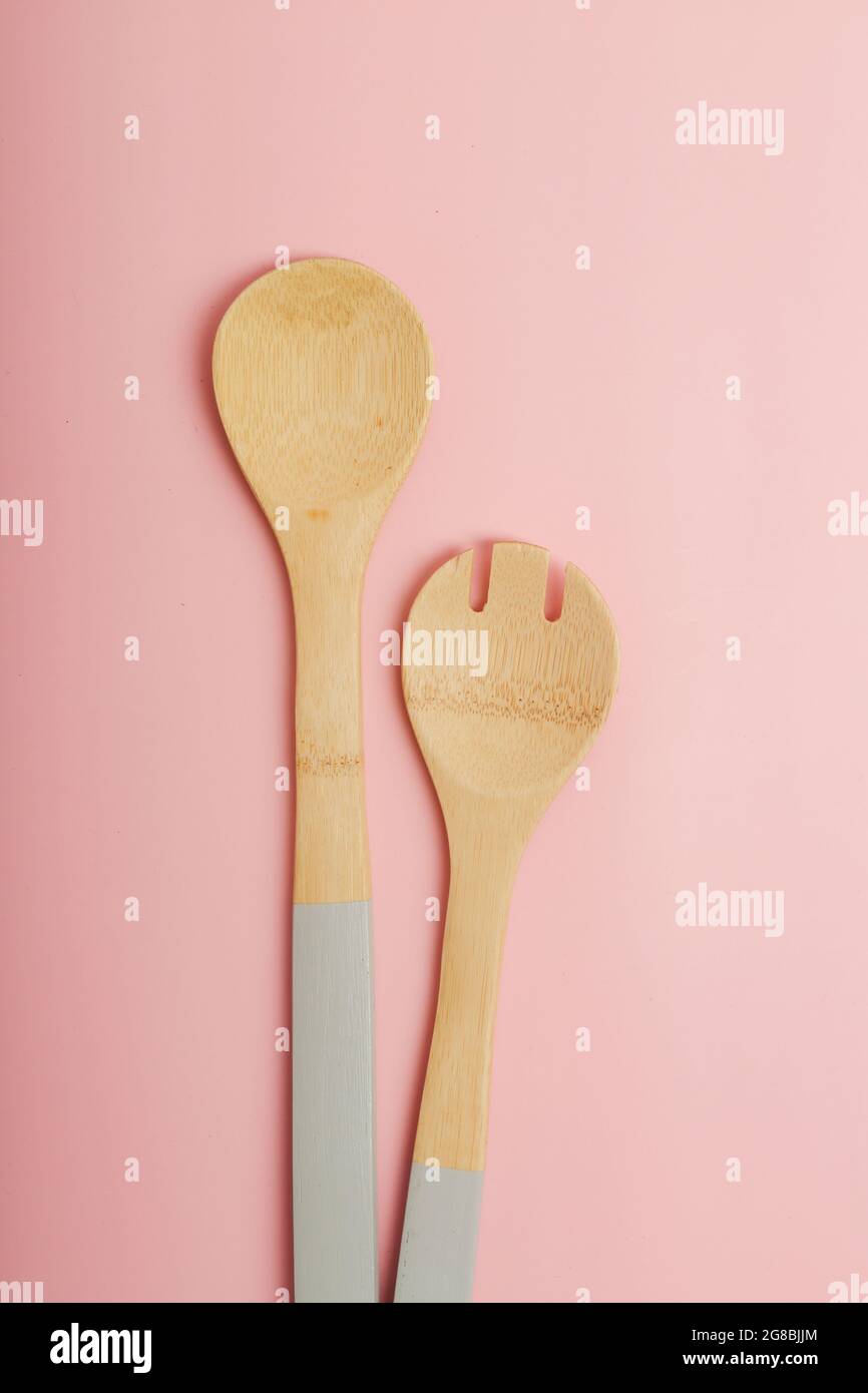 vertical photo of set of wooden kitchen spoons on pink background Stock ...