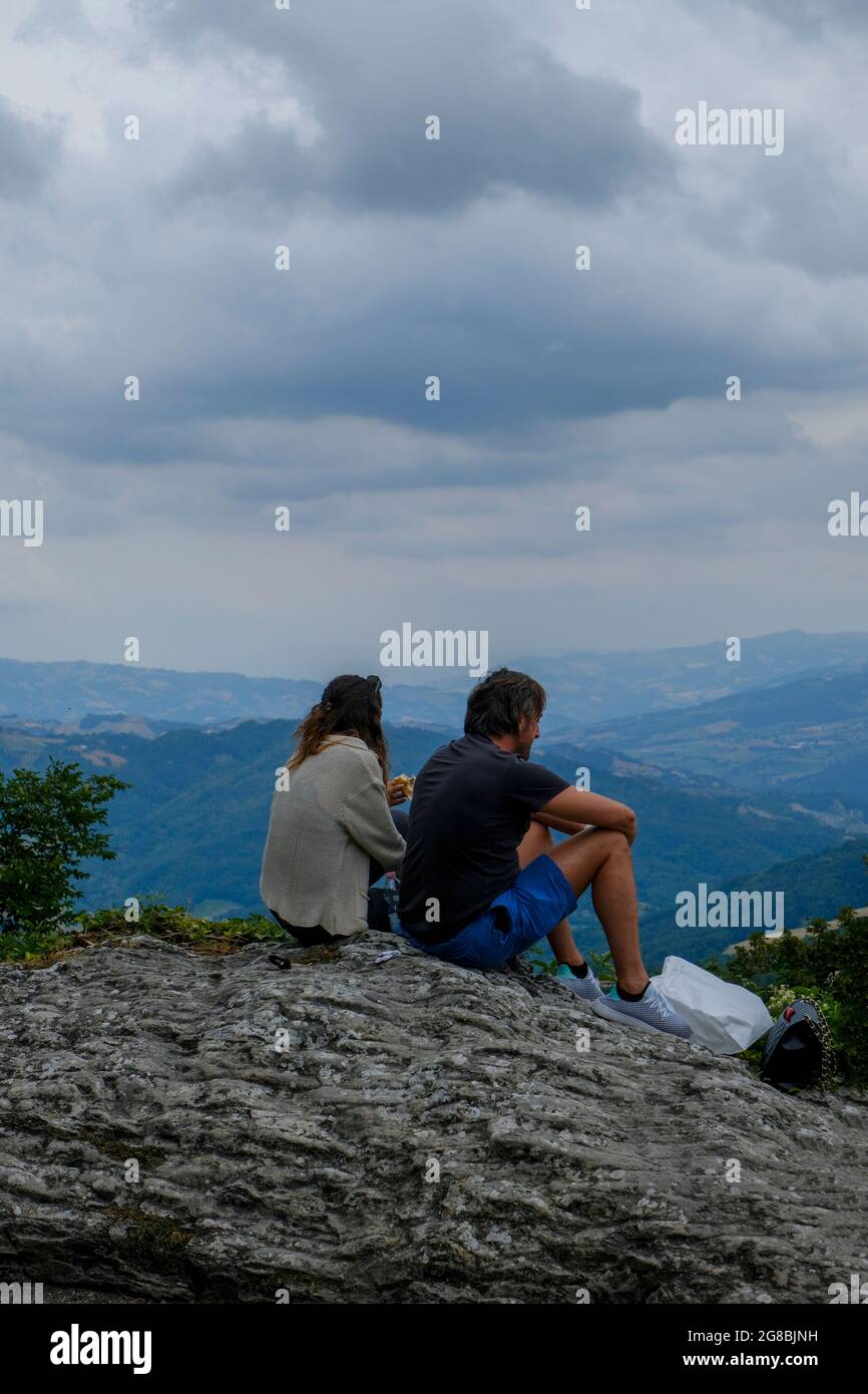 Reggio Emilia, Italy: couple sitting in the mountains, eating and ...