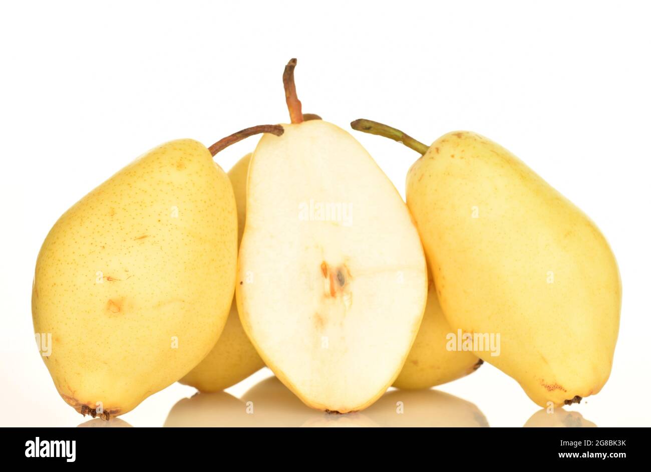 Several whole and one half organic yellow pears, close-up, isolated on ...