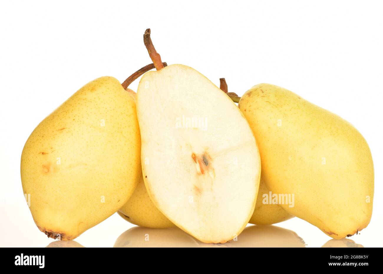 Several whole and one half organic yellow pears, close-up, isolated on ...