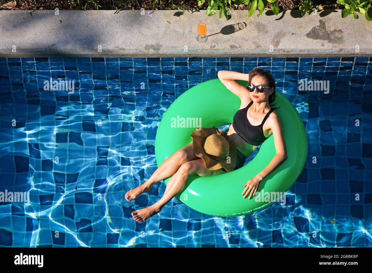 Beautiful woman laying by the pool hi-res stock photography and images ...