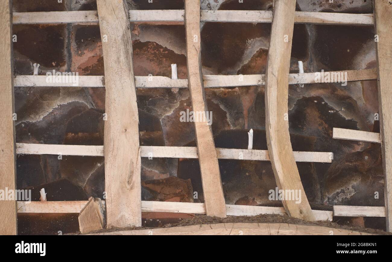 Sheep ribs are used to secure the stone roofing tiles on a traditional ...
