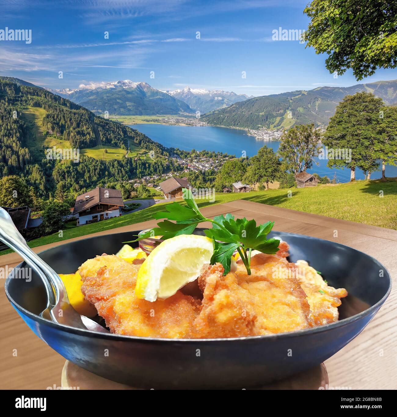 Traditional austrian food (Vinner schnitzel) against Zell am see ...