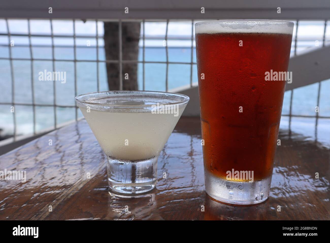 Closeup of a glass of refreshing cold lychee martini and red ale on the ...