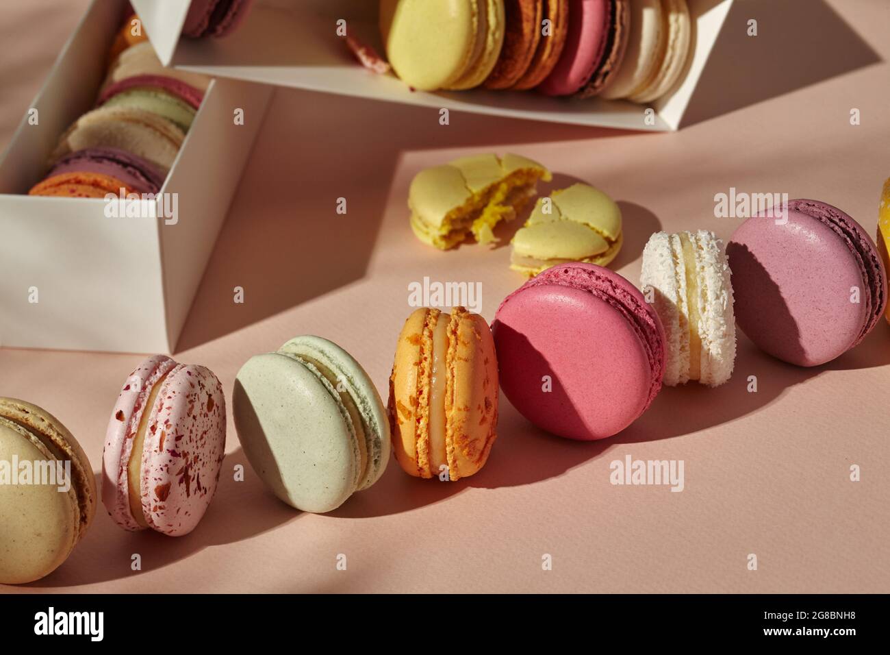 Assorted macarons taken out of boxes and lined up Stock Photo - Alamy