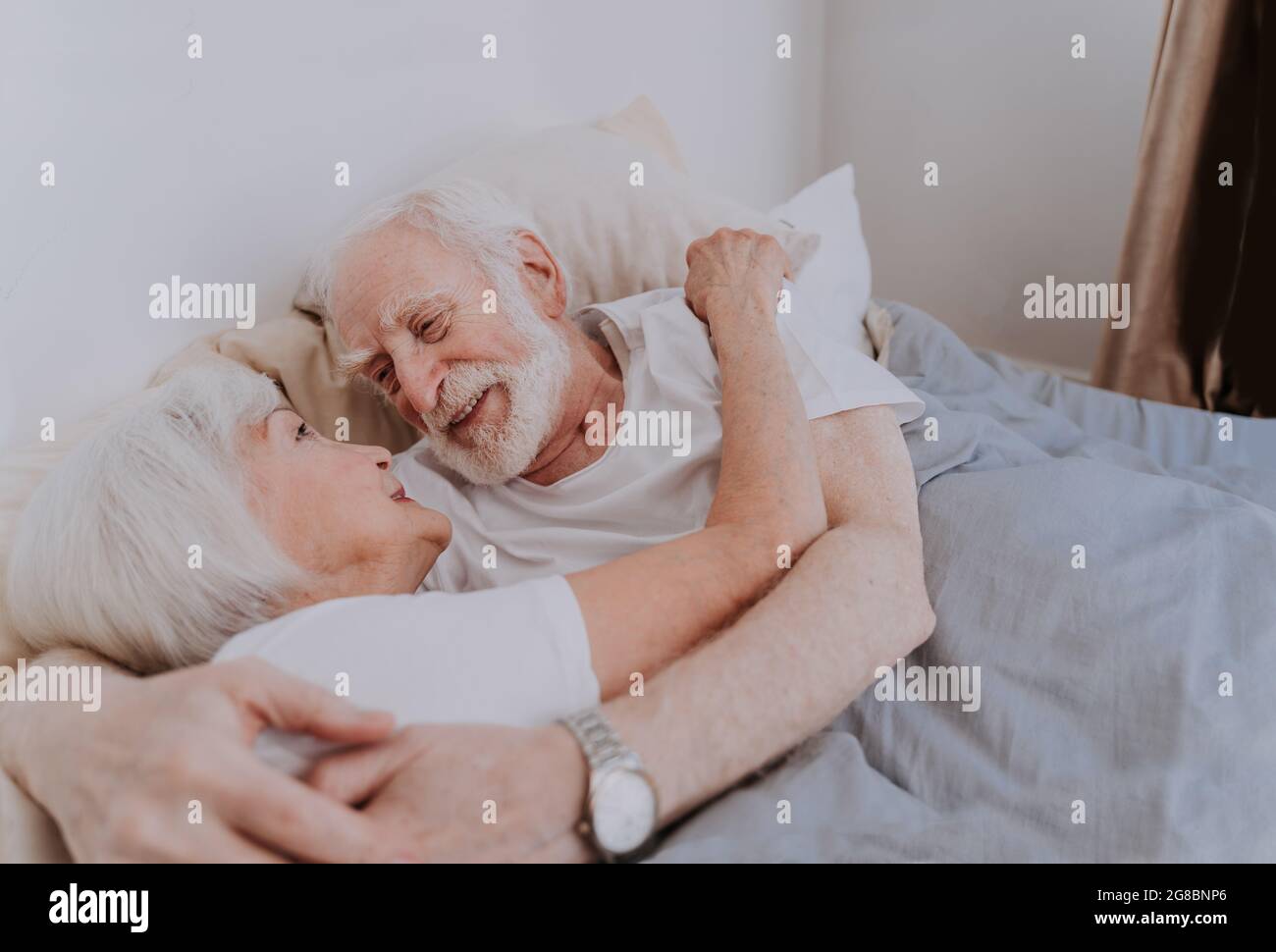 Mature couple cuddle bed hi-res stock photography and images - Alamy