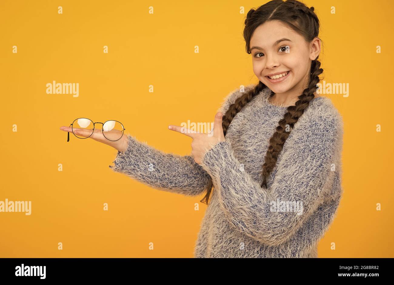 stylish teen has good vision. teenage girl presenting product. vision ...