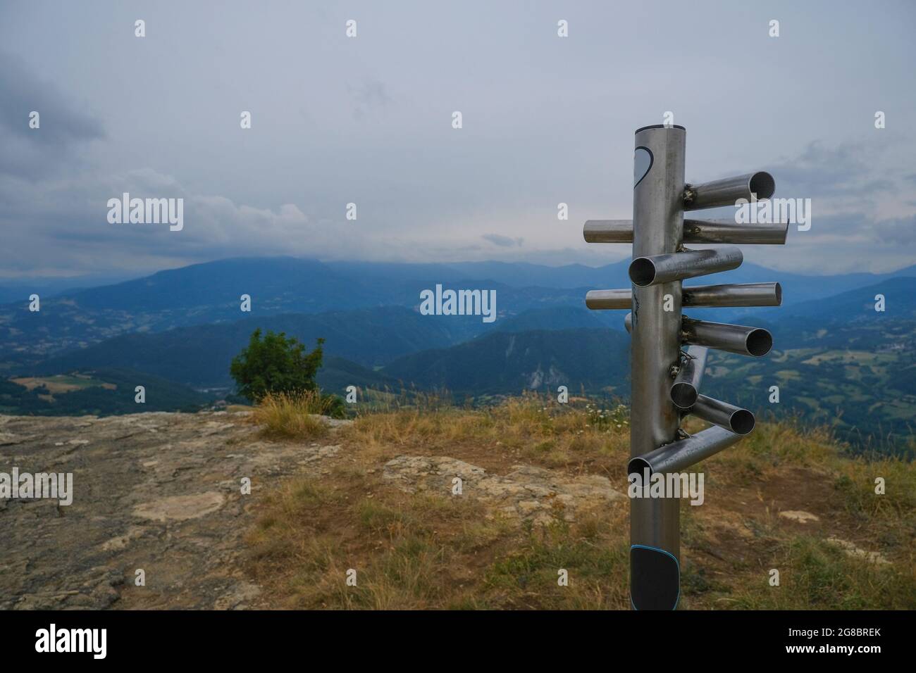 silver-colored metal signpost in the mountains close-up across aerial ...