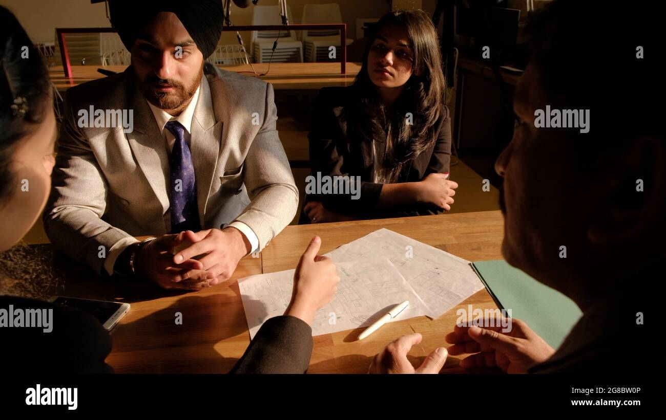 Closeup shot of a group of Indian colleagues working in the office ...