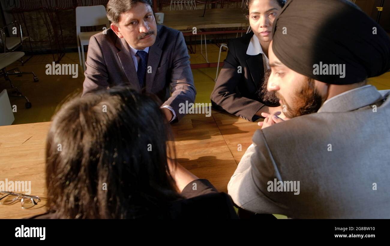 Closeup shot of a group of Indian colleagues working in the office ...