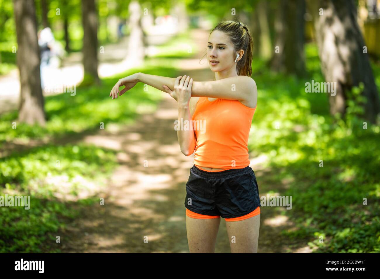 Female athlete stretching shoulders hi-res stock photography and images ...