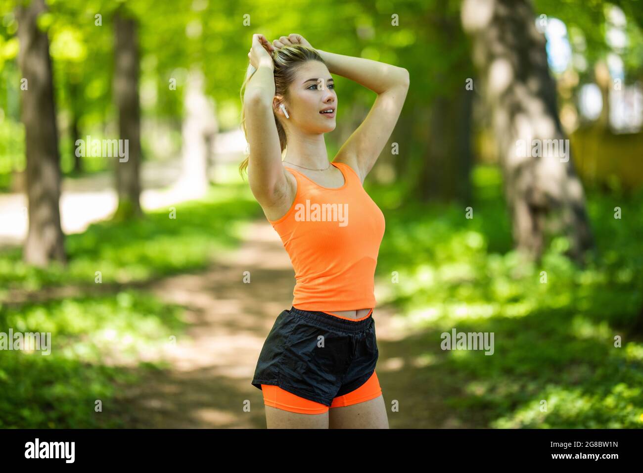 Fitness woman runner relaxing after running and working out outdoors ...