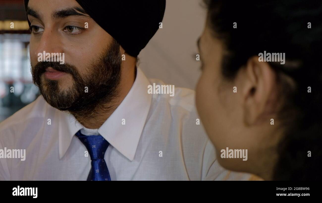 Senior boss giving an advice to a young junior office worker who ...
