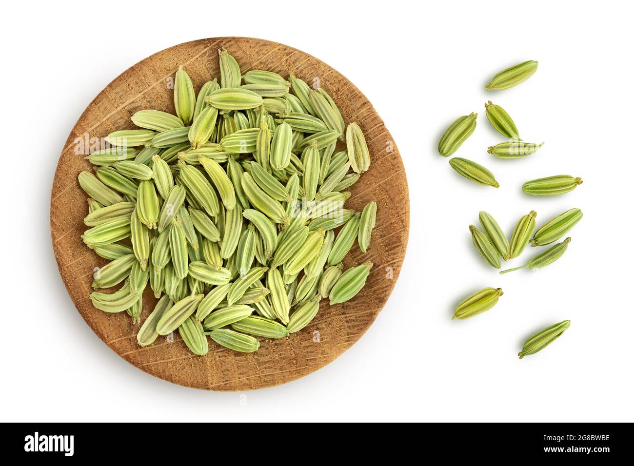 Dried fennel seeds in wooden bowl isolated on white background with ...