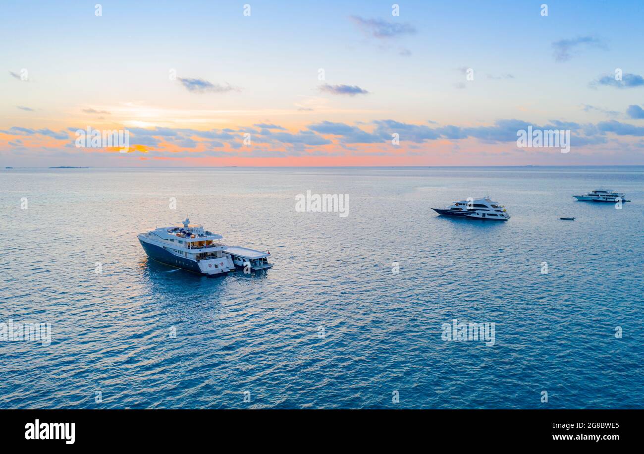 Aerial view of sunset and tourist ships in the Indian ocean with a ...