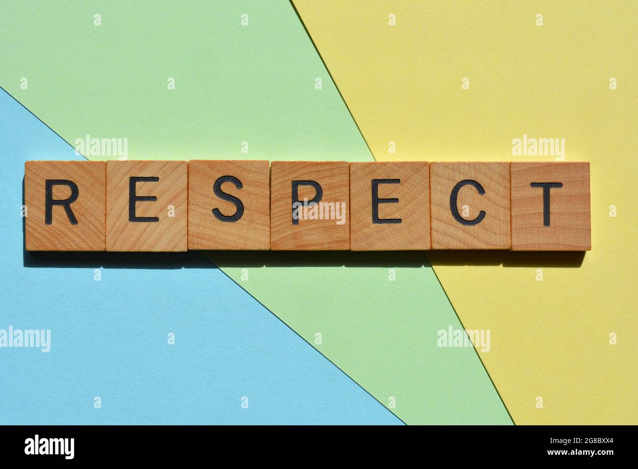 Respect, word in wooden alphabet letters isolated on pastel coloured ...