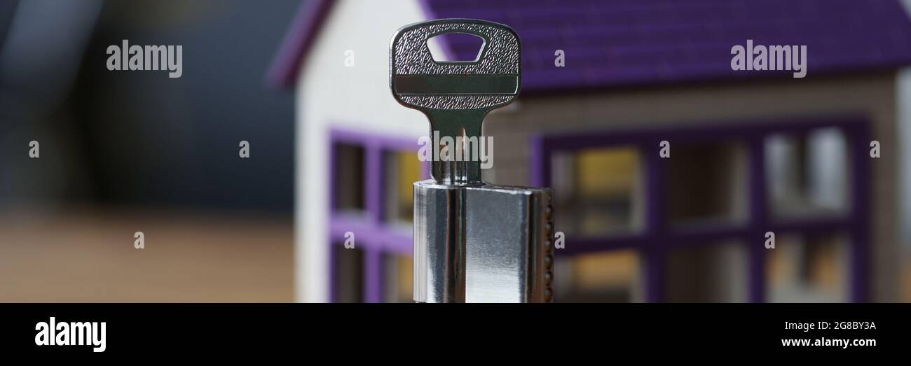 Keyhole and keys lying on background of toy wooden house. Installation ...