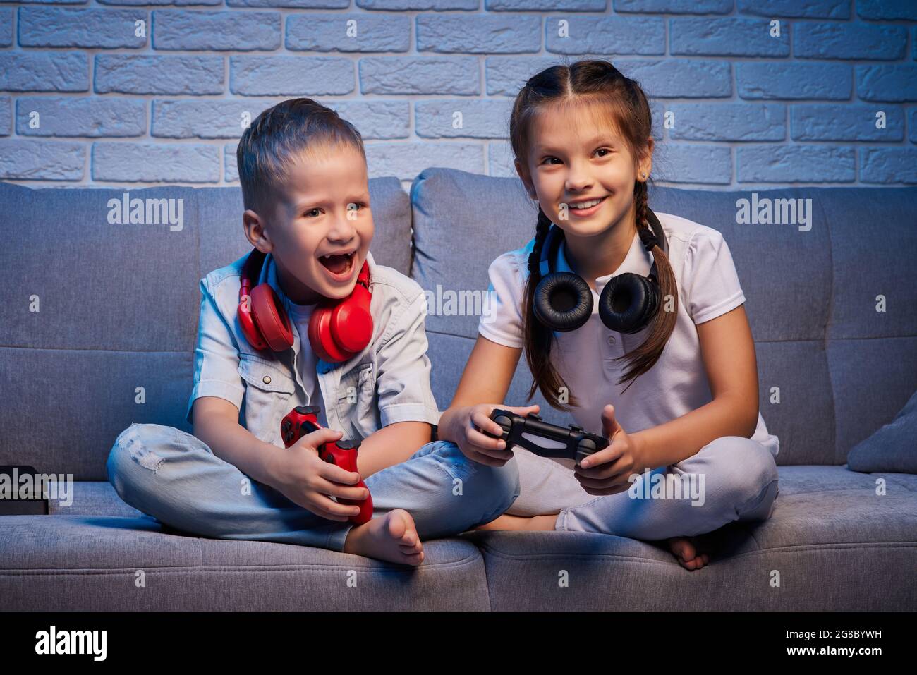 children playing video game with game console Stock Photo - Alamy