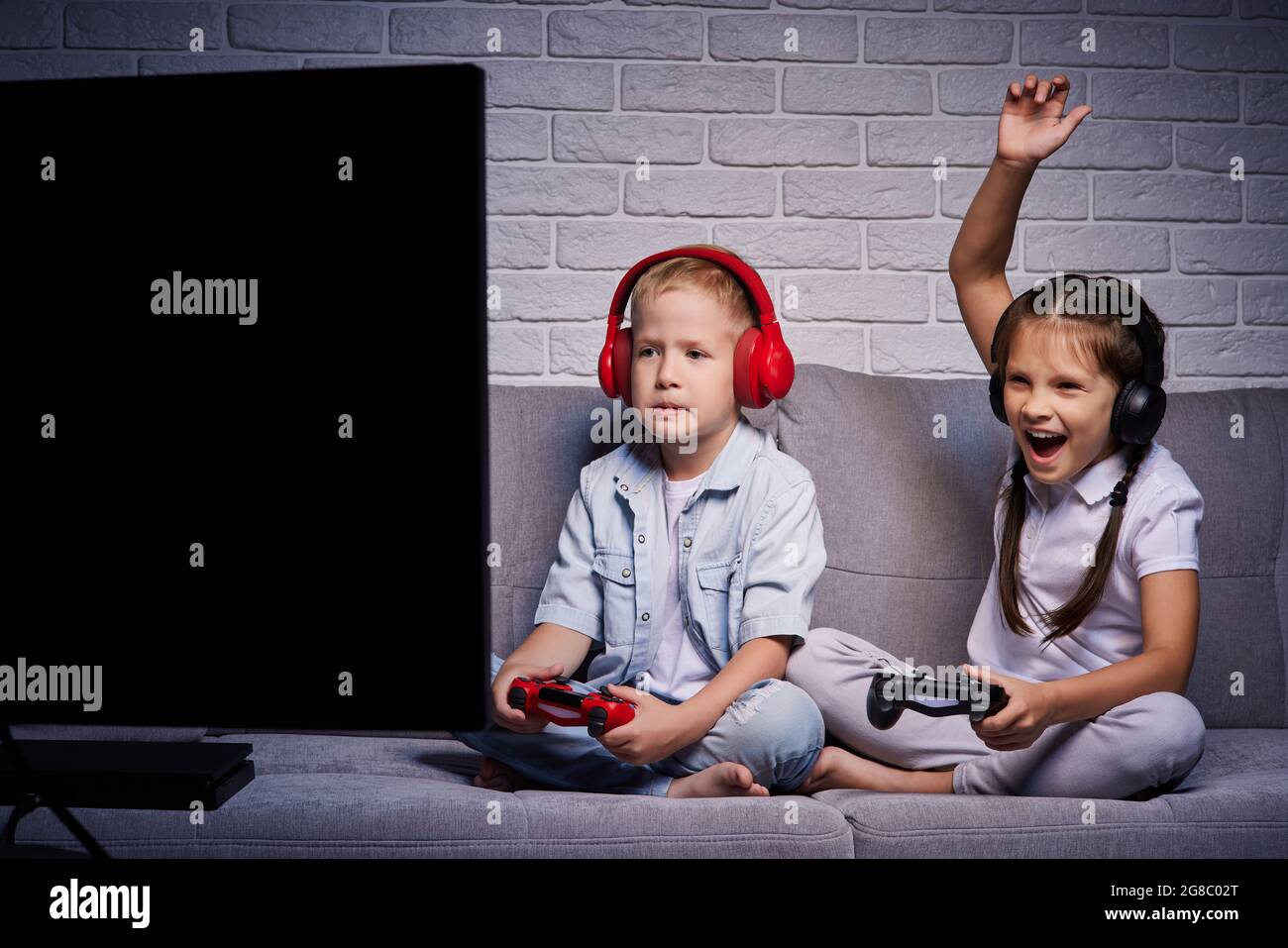 children playing video game with game console Stock Photo - Alamy