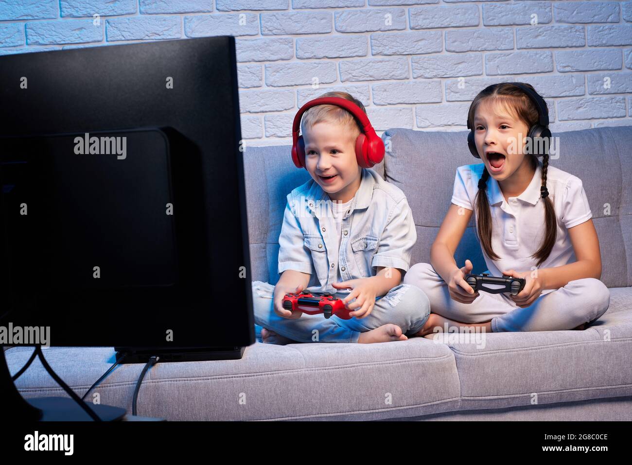 children playing video game with game console Stock Photo - Alamy