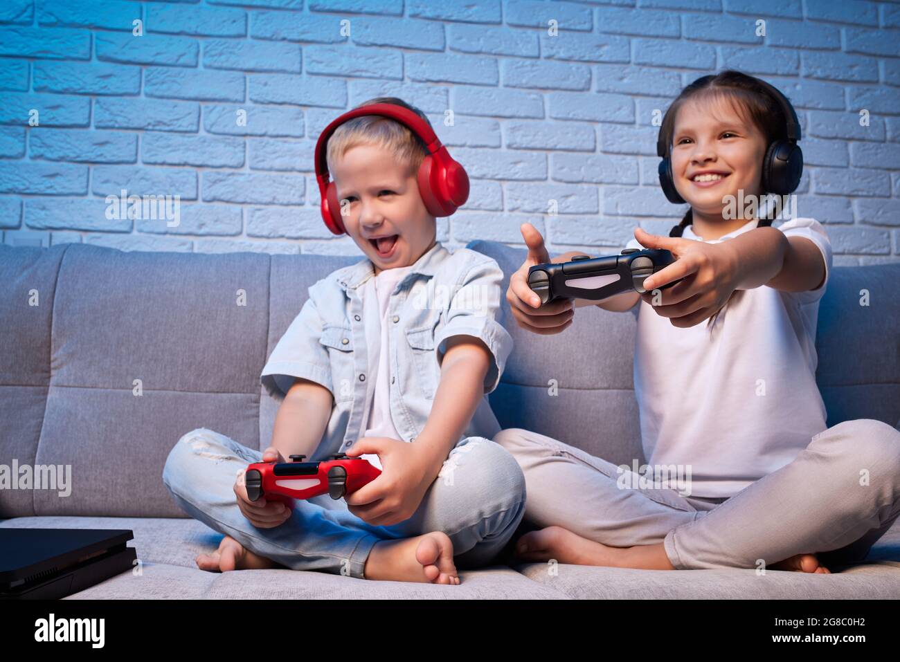 children playing video game with game console Stock Photo - Alamy
