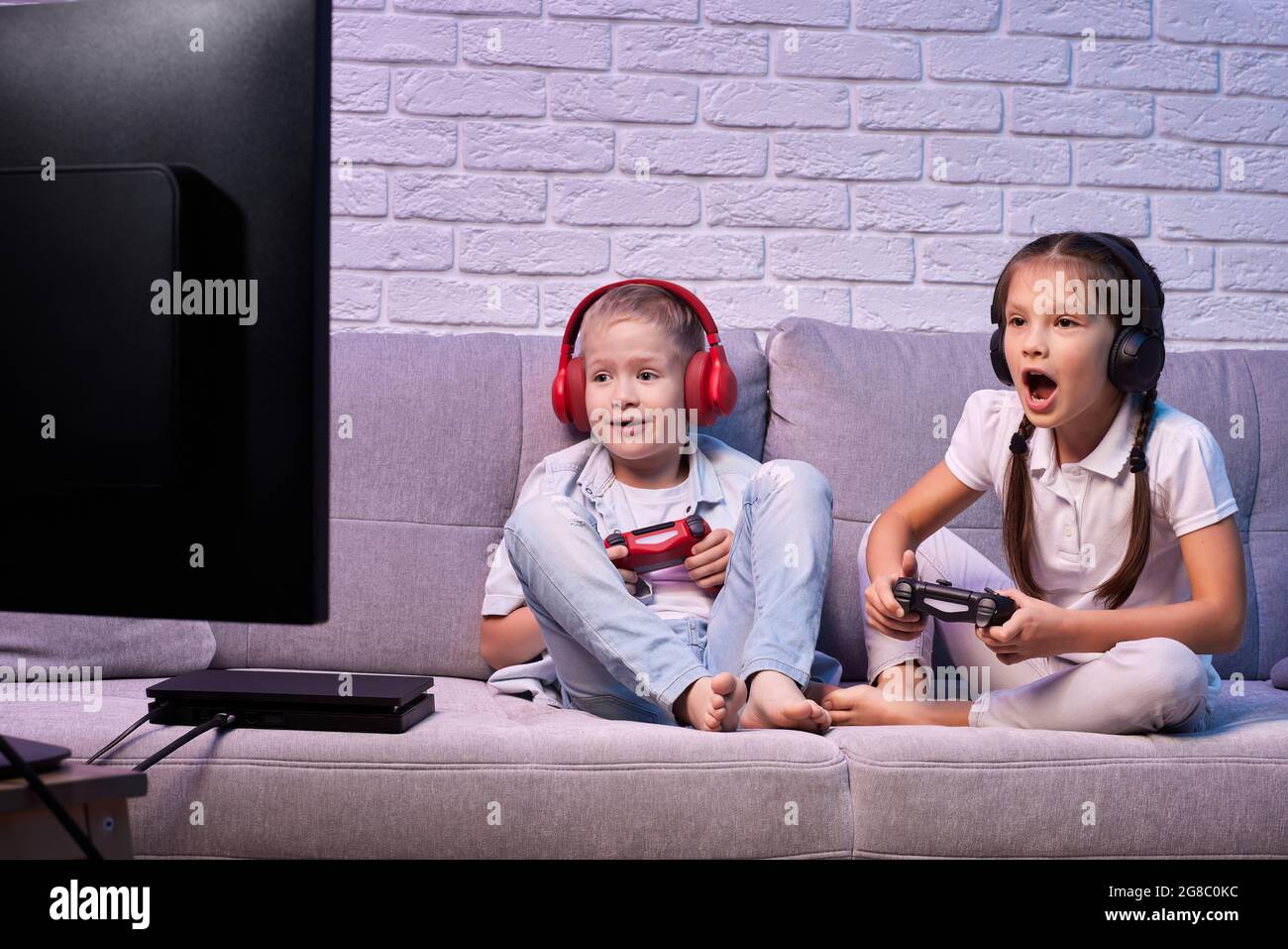 children playing video game with game console Stock Photo - Alamy