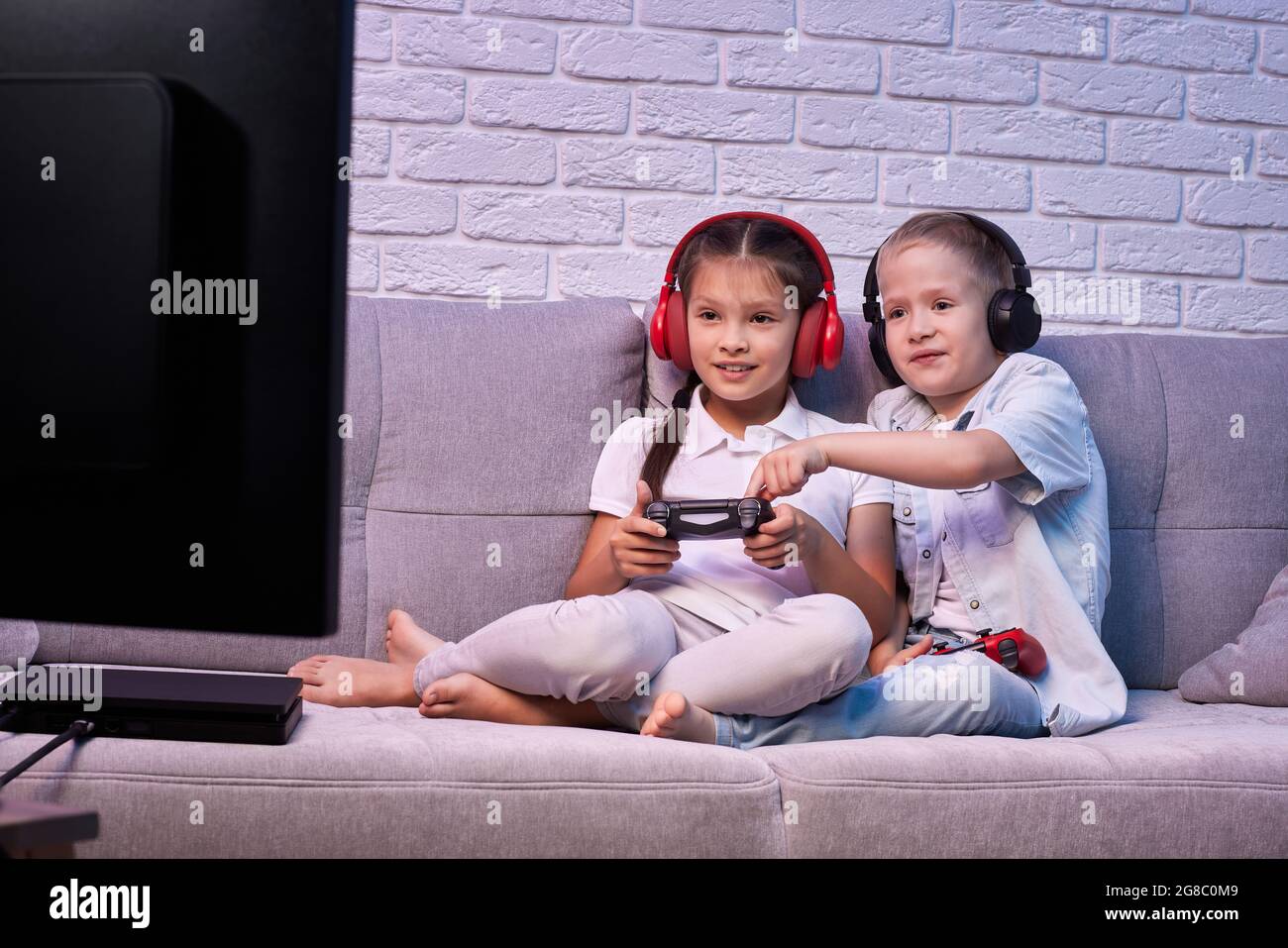 children playing video game with game console Stock Photo - Alamy
