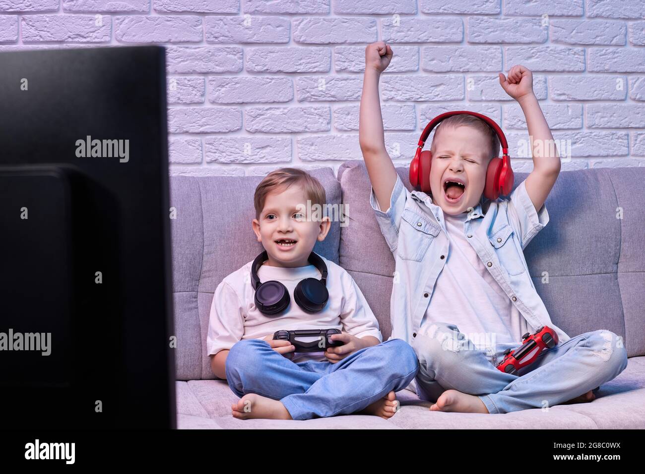 children playing video game with game console Stock Photo - Alamy