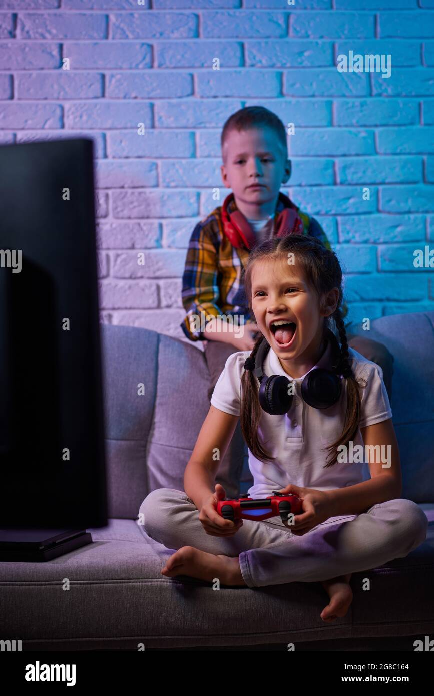 children playing video game with game console Stock Photo - Alamy