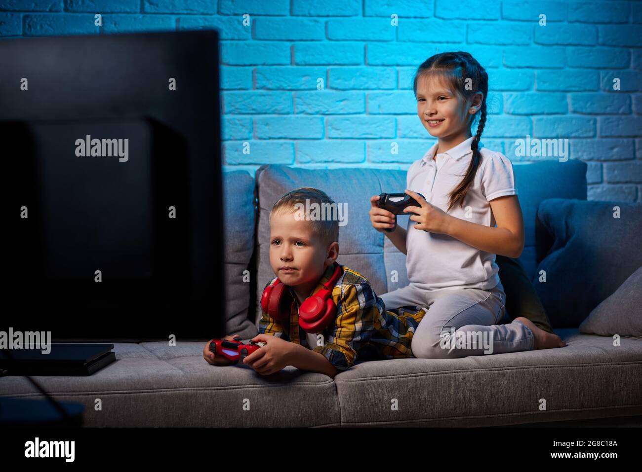 children playing video game with game console Stock Photo - Alamy