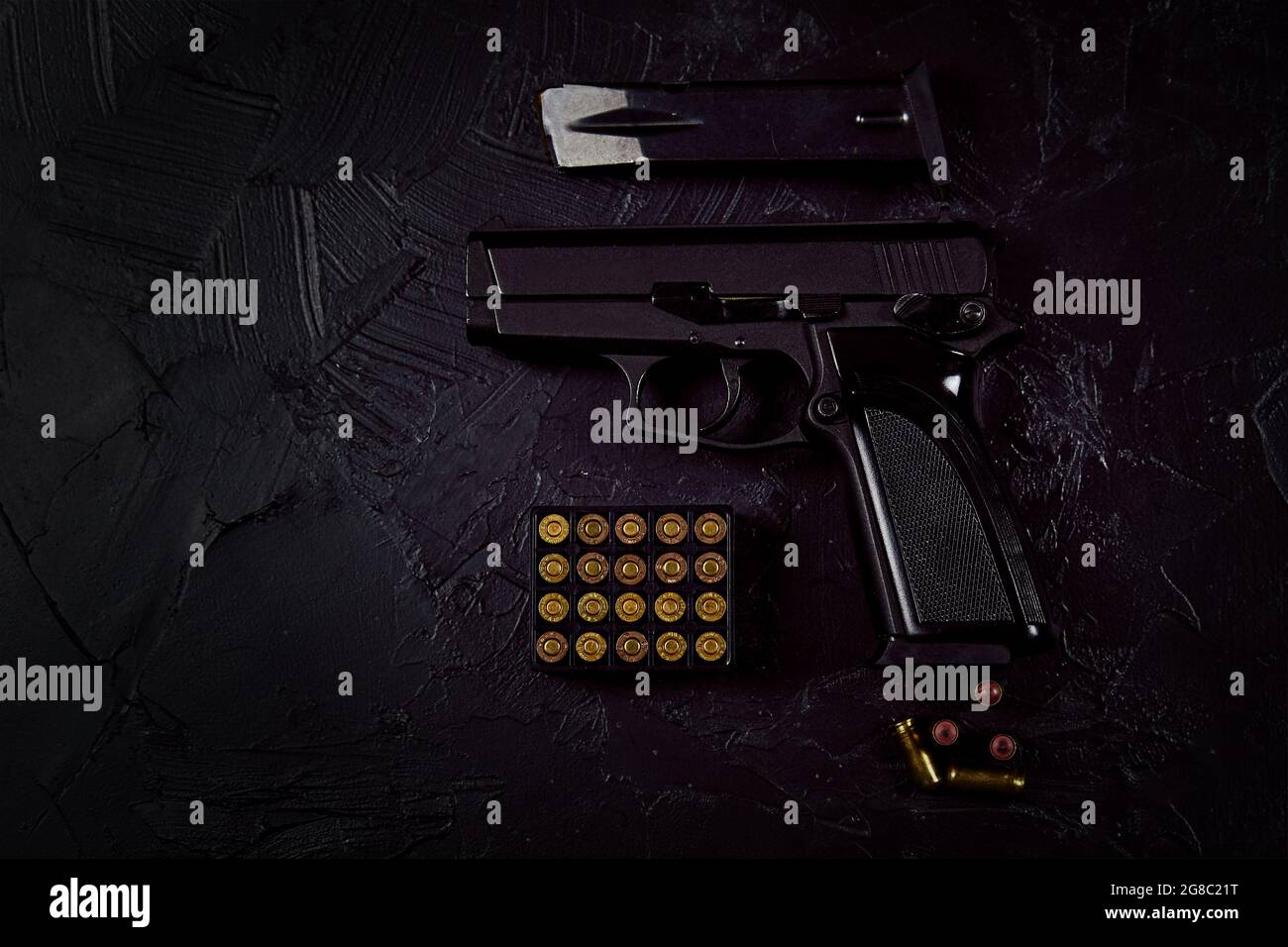 Flat lay of cartridges and gun on concrete background. Top view with ...