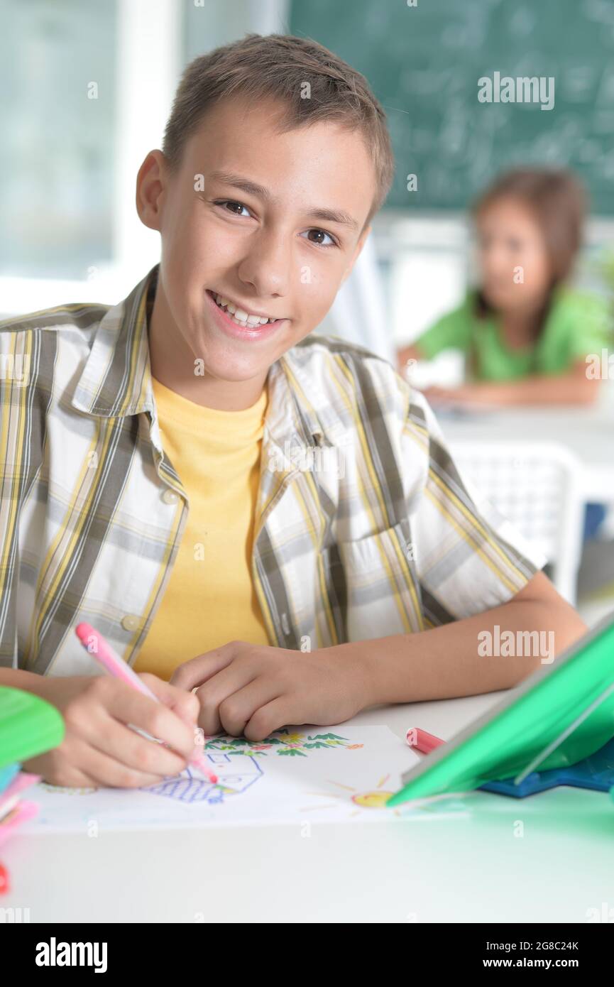 Portrait of a boy drawing with pencil Stock Photo - Alamy