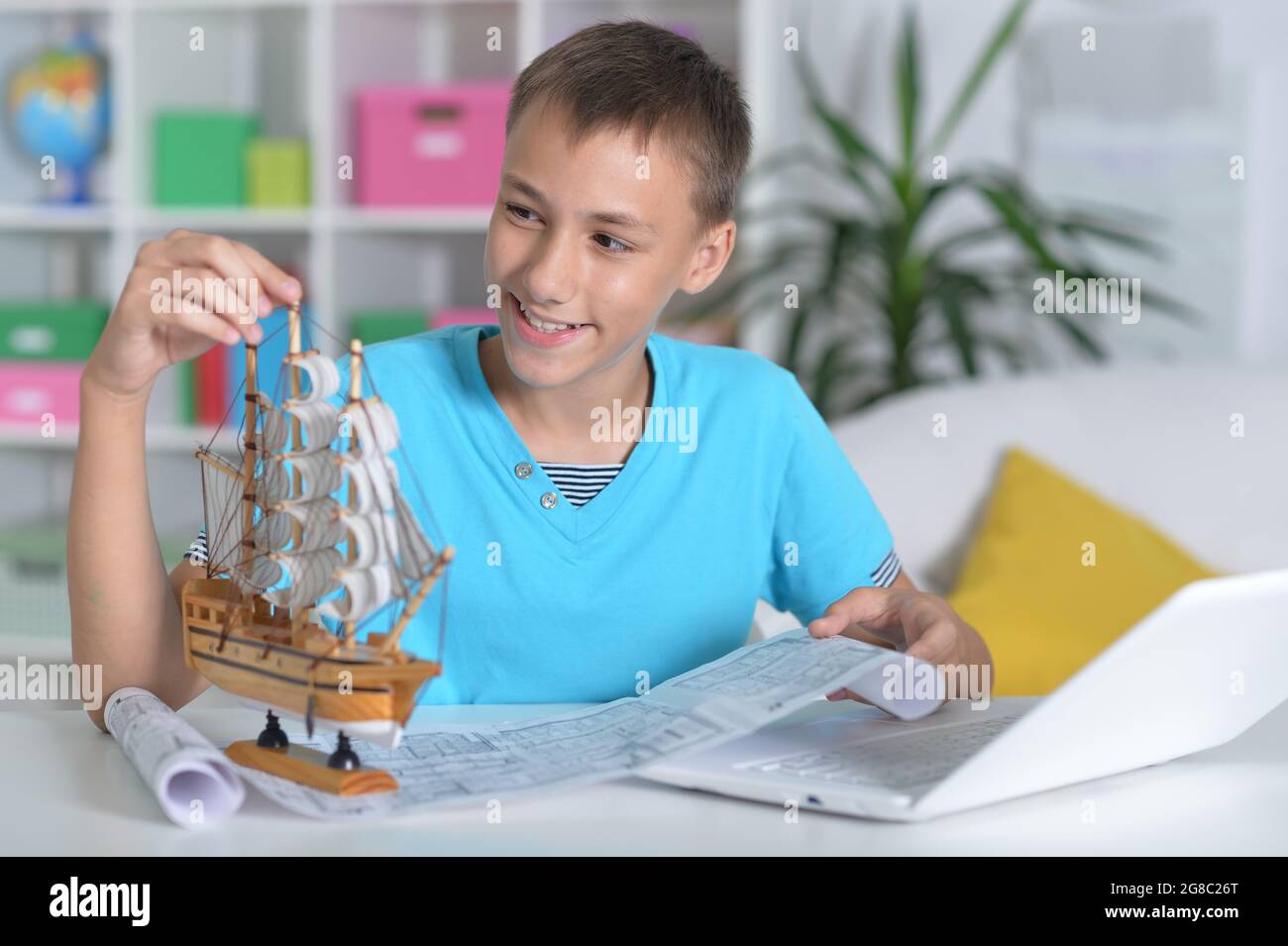 Portrait of a boy with a homemade toy-ship Stock Photo - Alamy