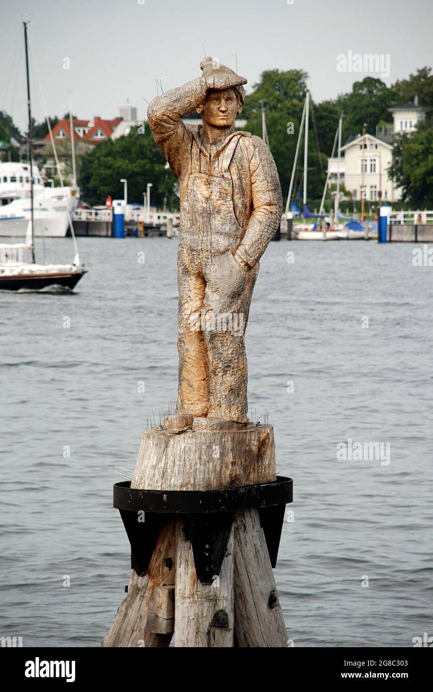 Beautiful wooden statue of a worker in Travemunde, Germany Stock Photo ...